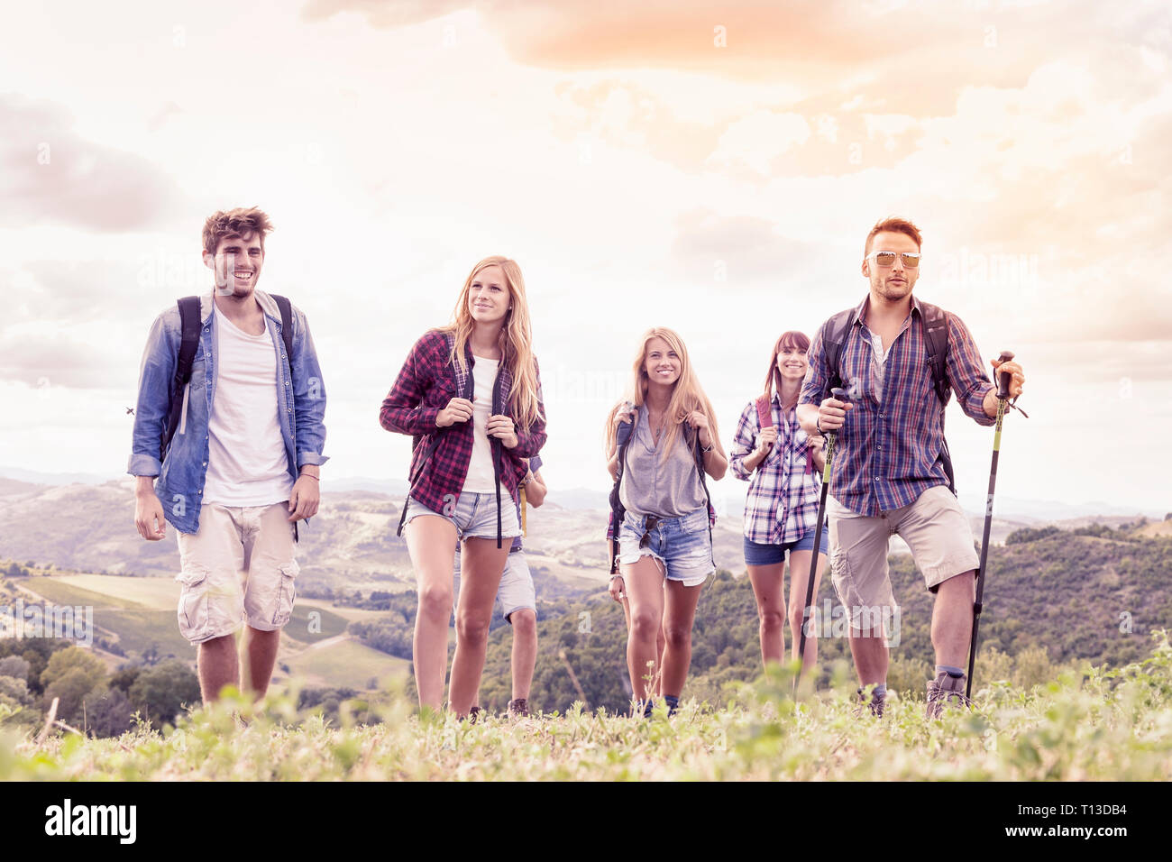 group of young hikers looks to the horizon over the mountain Stock ...