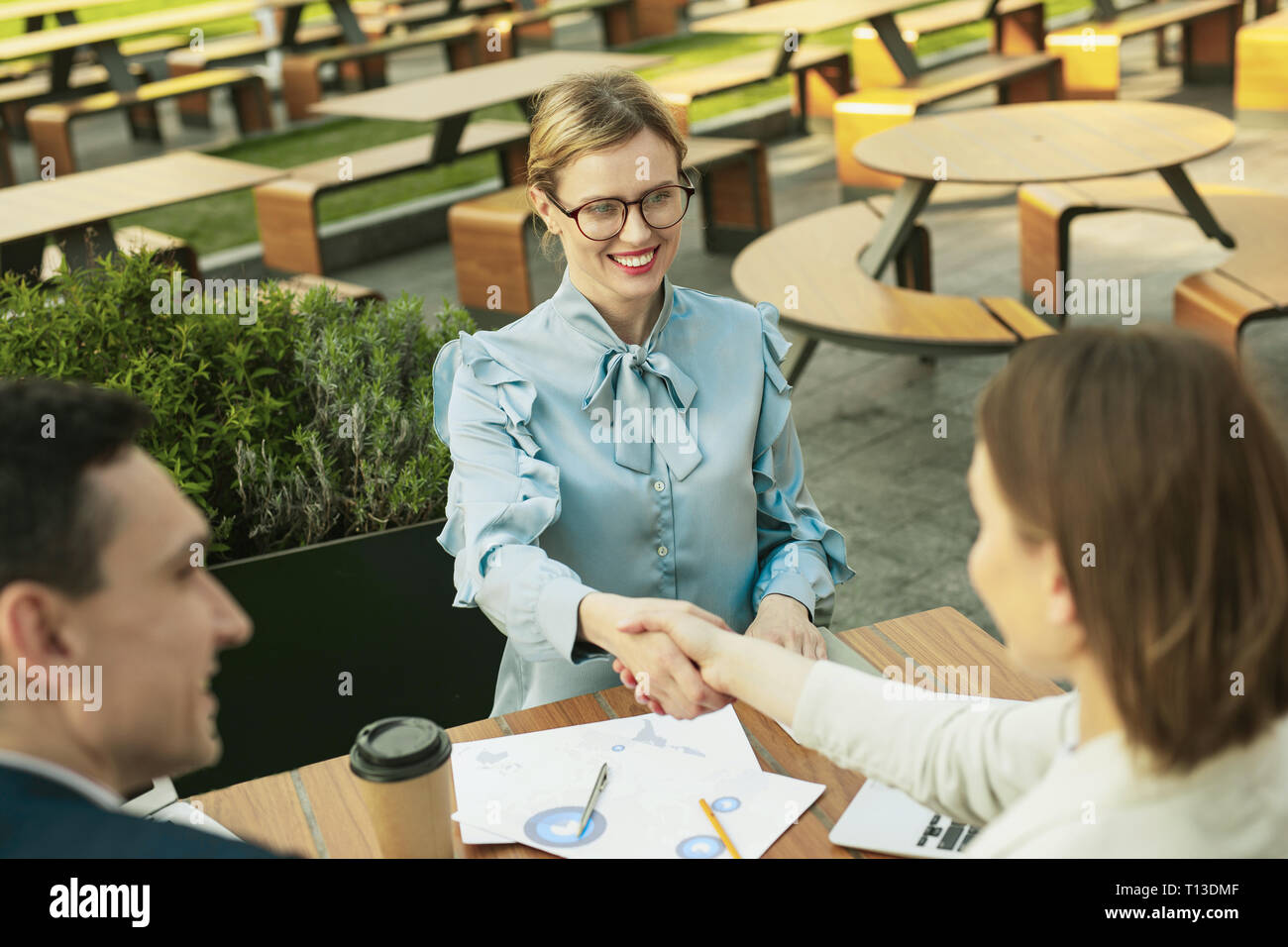 Happy joyful lady smiling when shaking hands Stock Photo - Alamy