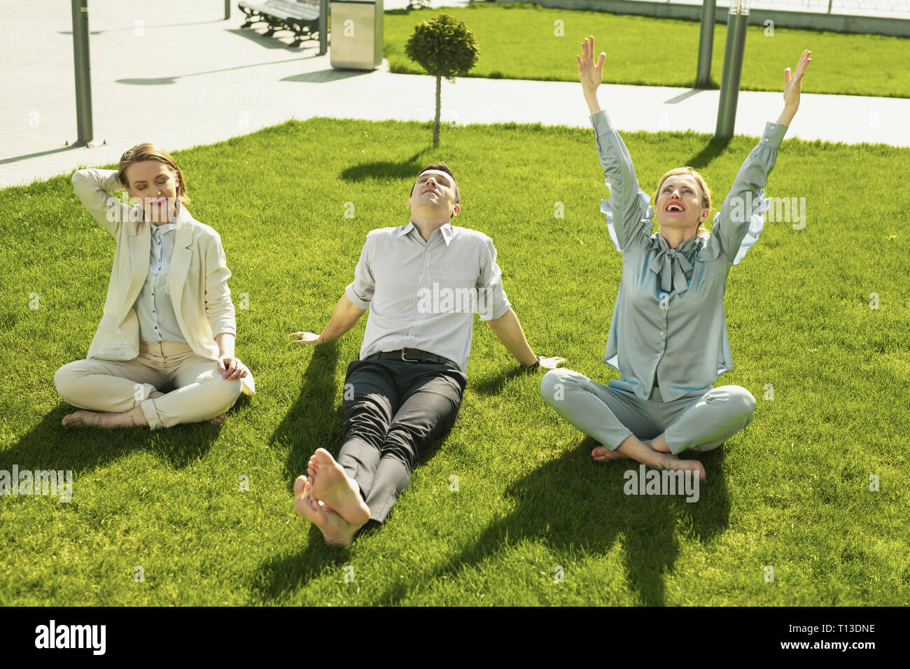 Beautiful smart colleagues resting after hard-working day at office ...