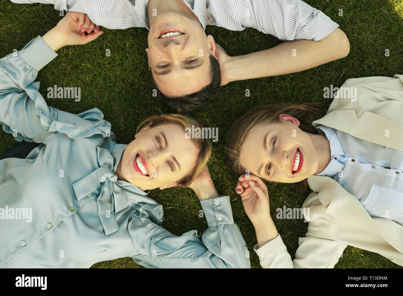 The best friend lying on green grass in park Stock Photo - Alamy