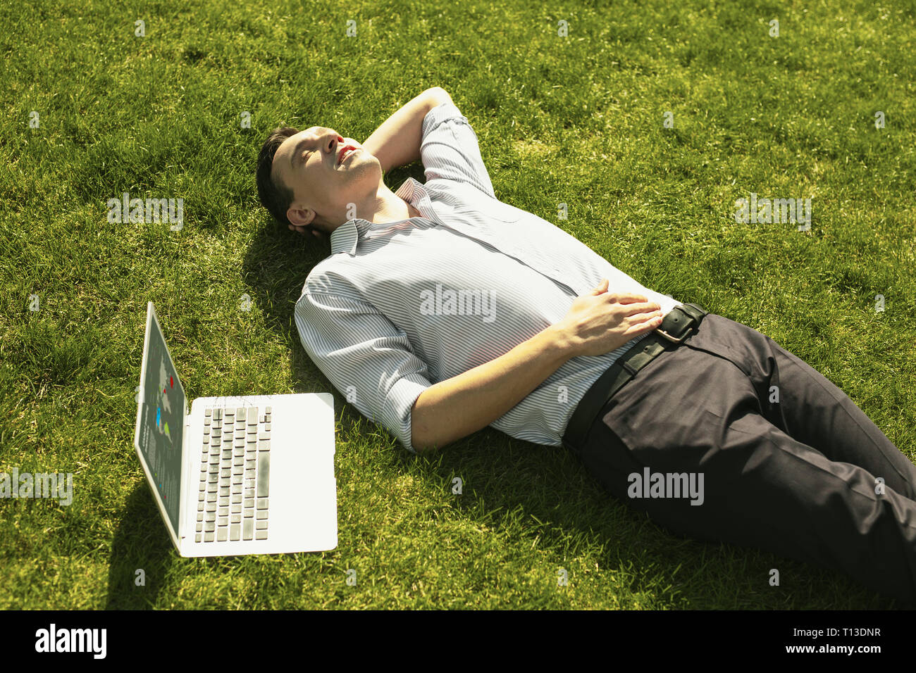 Handsome clever man resting while finishing his project Stock Photo - Alamy