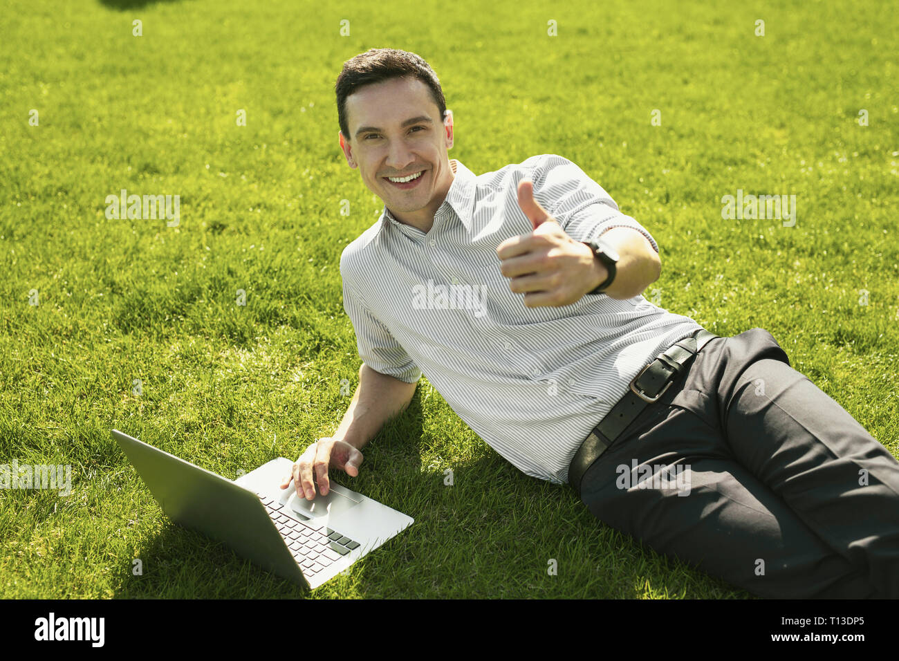 Young smart business worker enjoying his work Stock Photo - Alamy