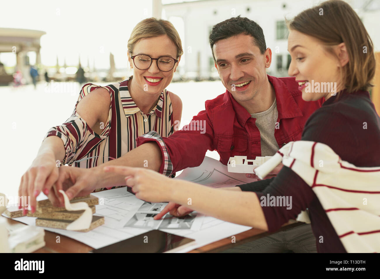 Smiling friendly company showing what preferring Stock Photo - Alamy