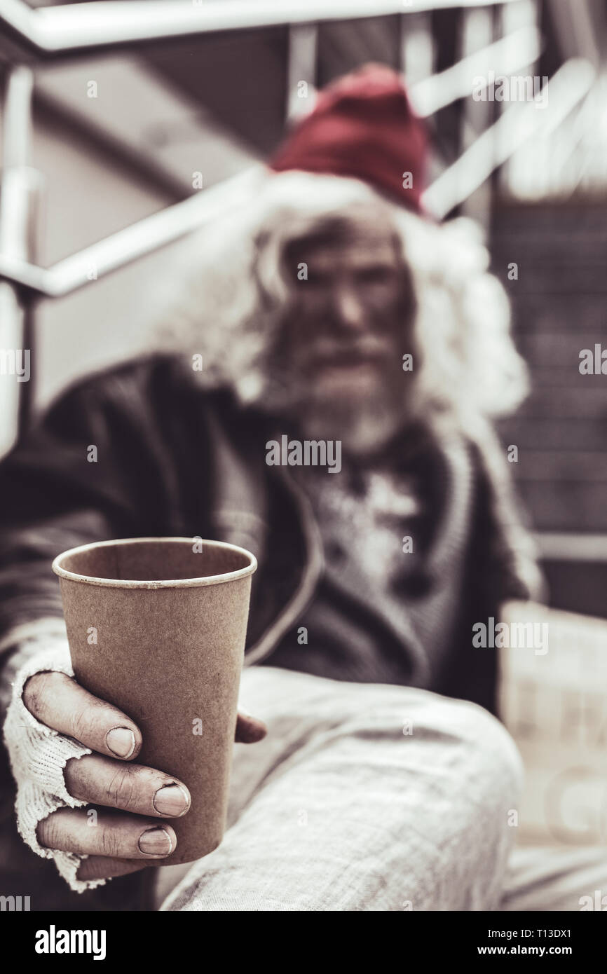 Close up photo of plastic cup which holding by old man Stock Photo - Alamy
