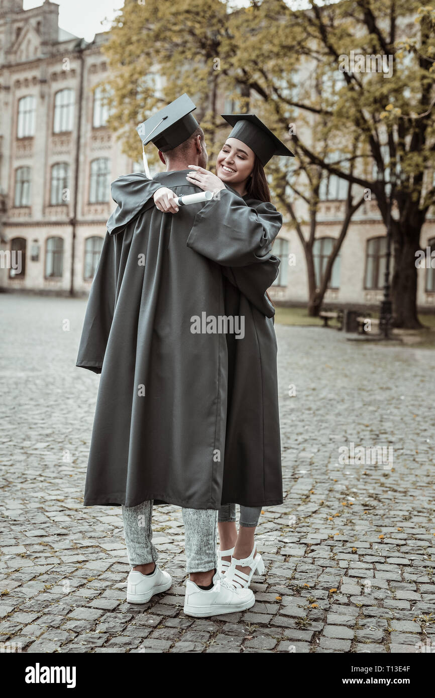 Cheerful international students wearing uniform for graduation Stock ...