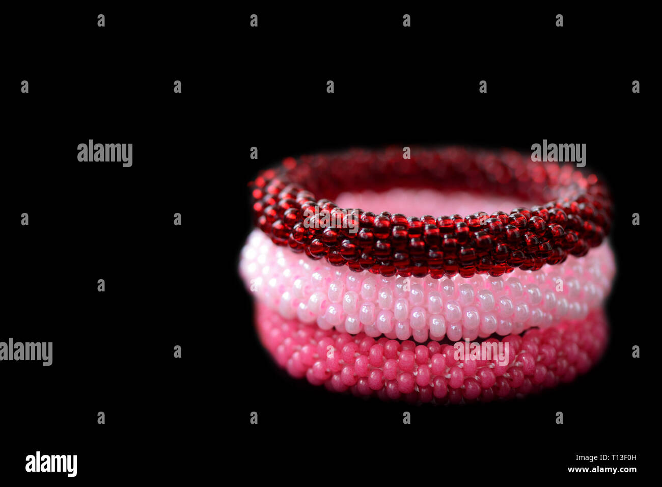 Set of three kids bracelets isolated on a black background close up ...