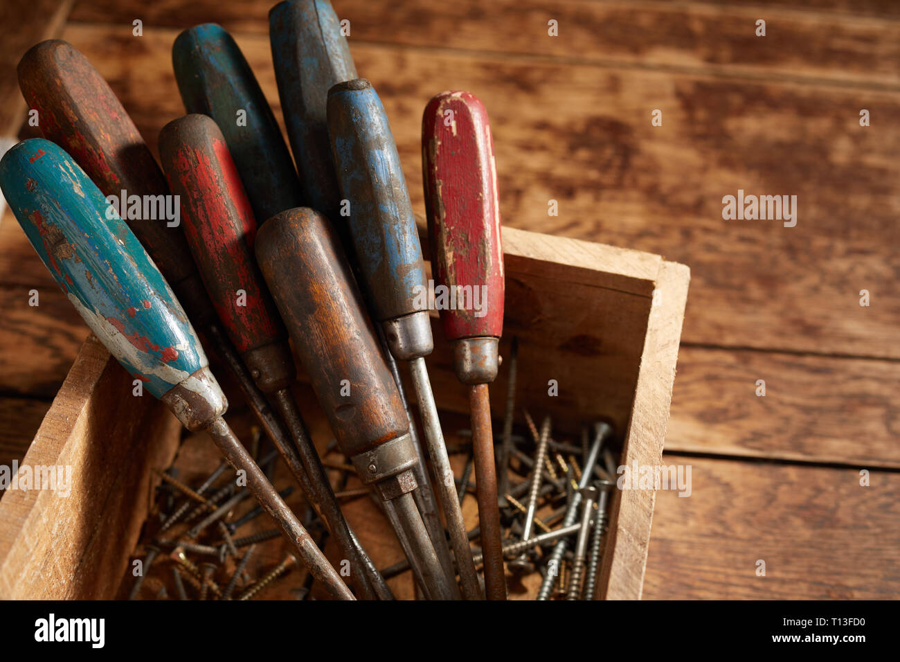 Set of old vintage screwdrivers with worn wooden handles standing ...