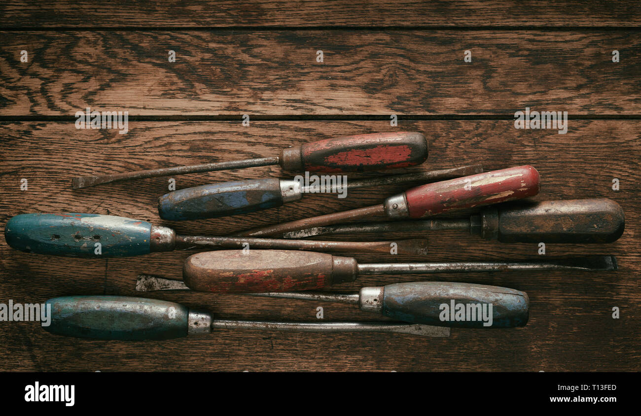 Selection of old wooden handled vintage screwdrivers arranged as a ...