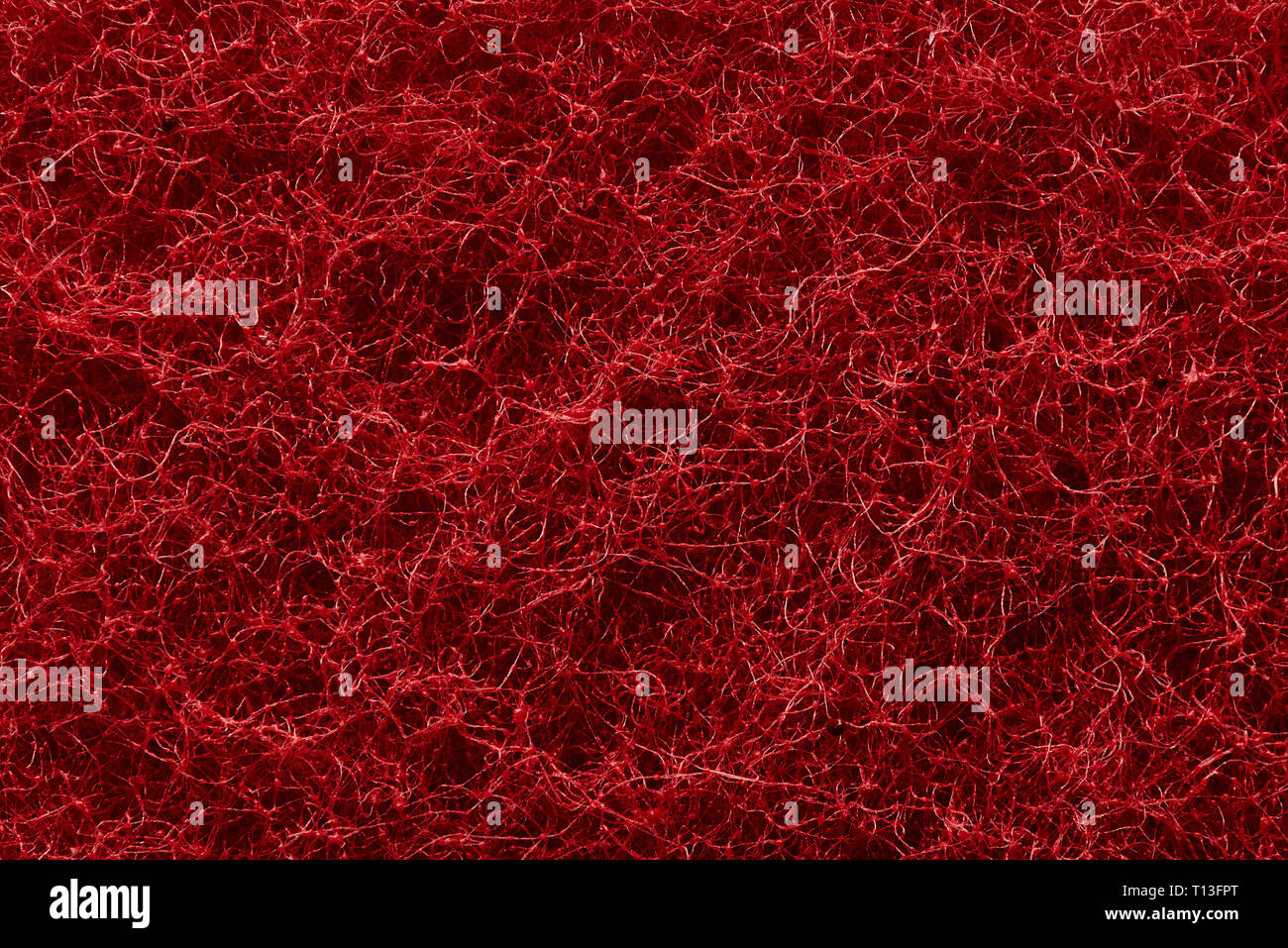The texture of the surface of interwoven red threads of abrasive ...