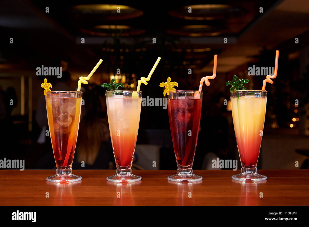 Row of different cocktails with straws on a dark background Stock Photo ...