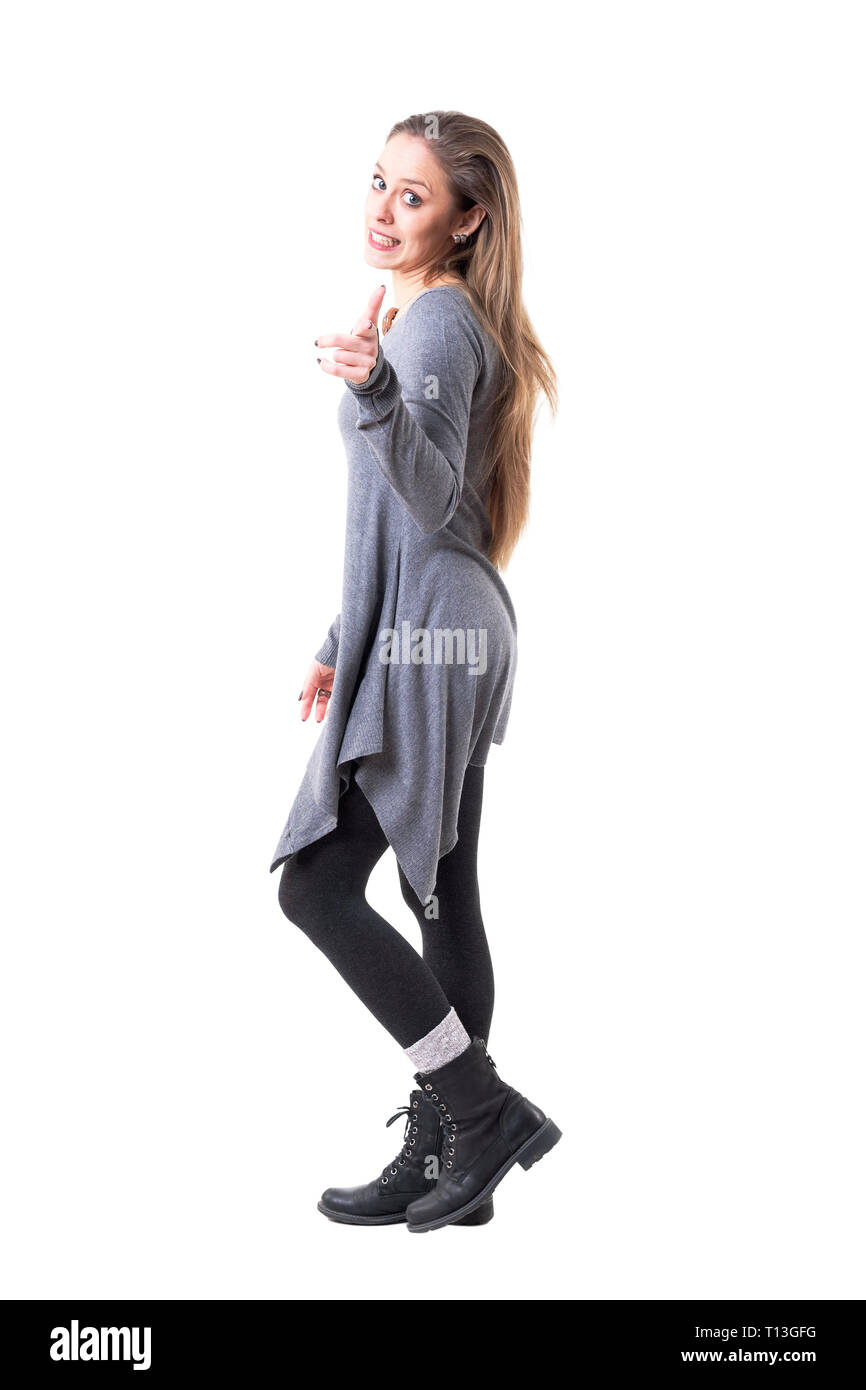 Cute funny expressive young blonde woman walking and pointing at camera ...