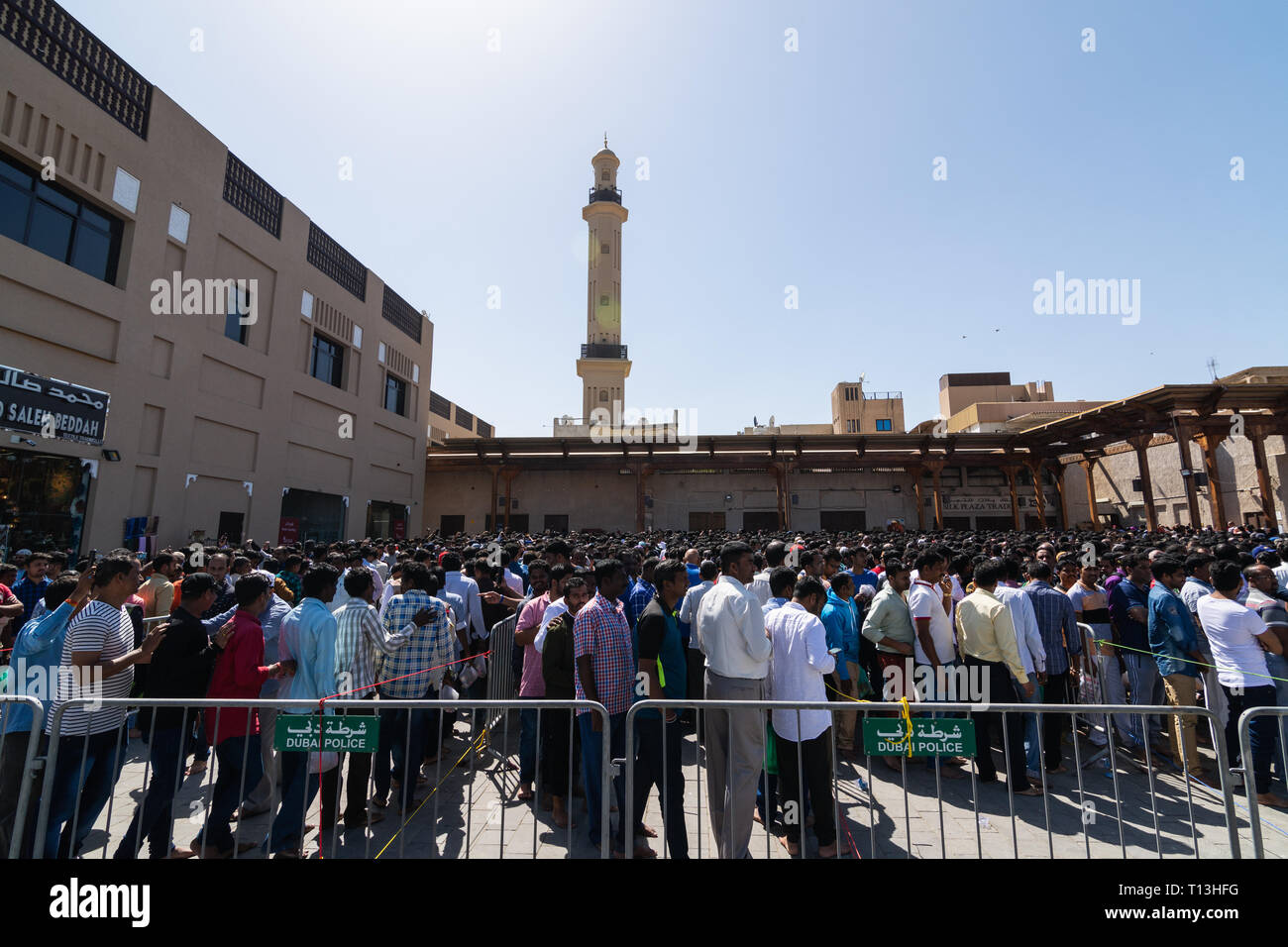 DUBAI, UNITED ARAB EMIRATES - MARCH 2019: crowd of men queue up to ...
