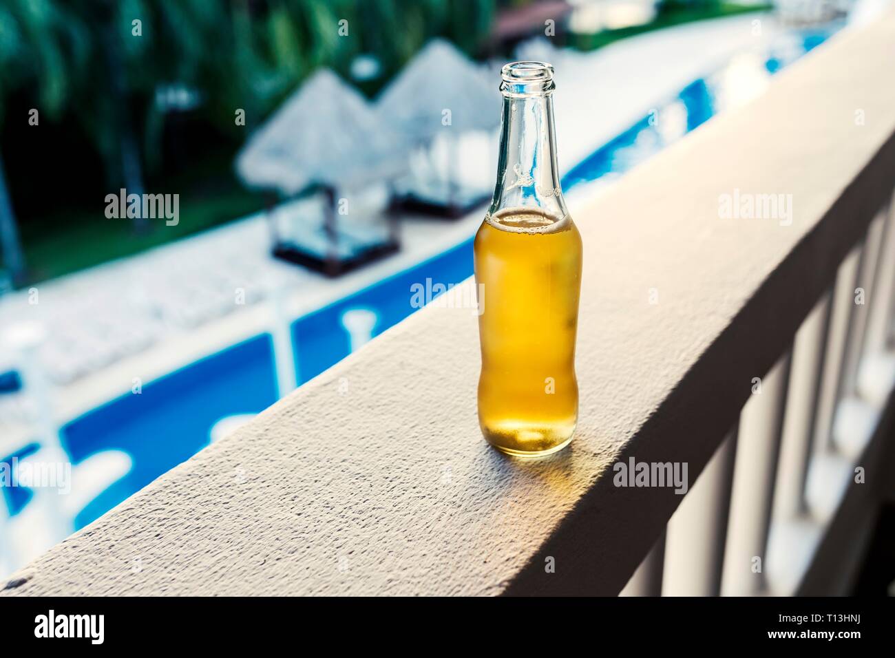 Cool refreshing bottle of lager or beer on a luxury tropical, caribbean ...