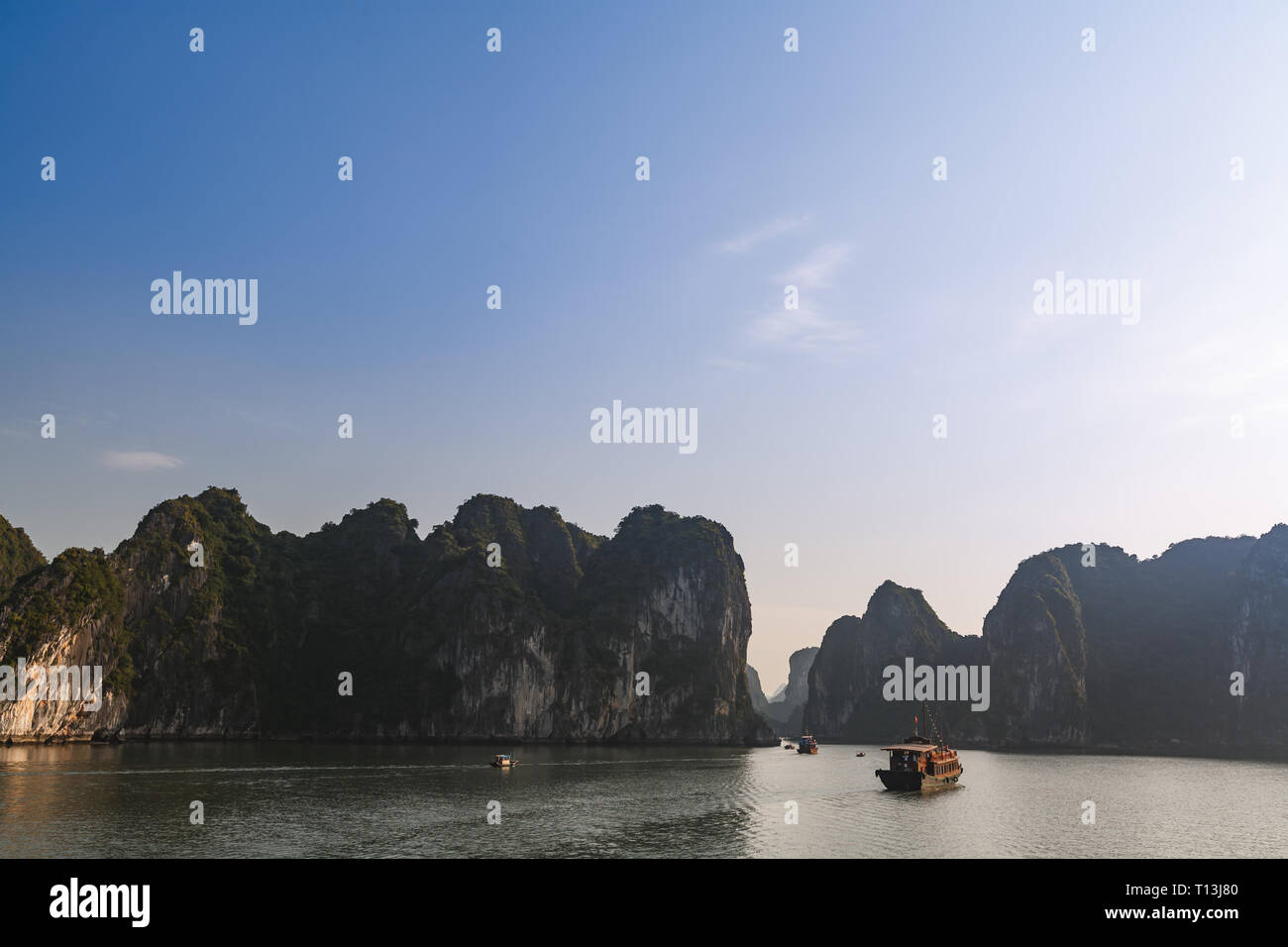 Halong Bay river traffic large and small passes before huge karst ...