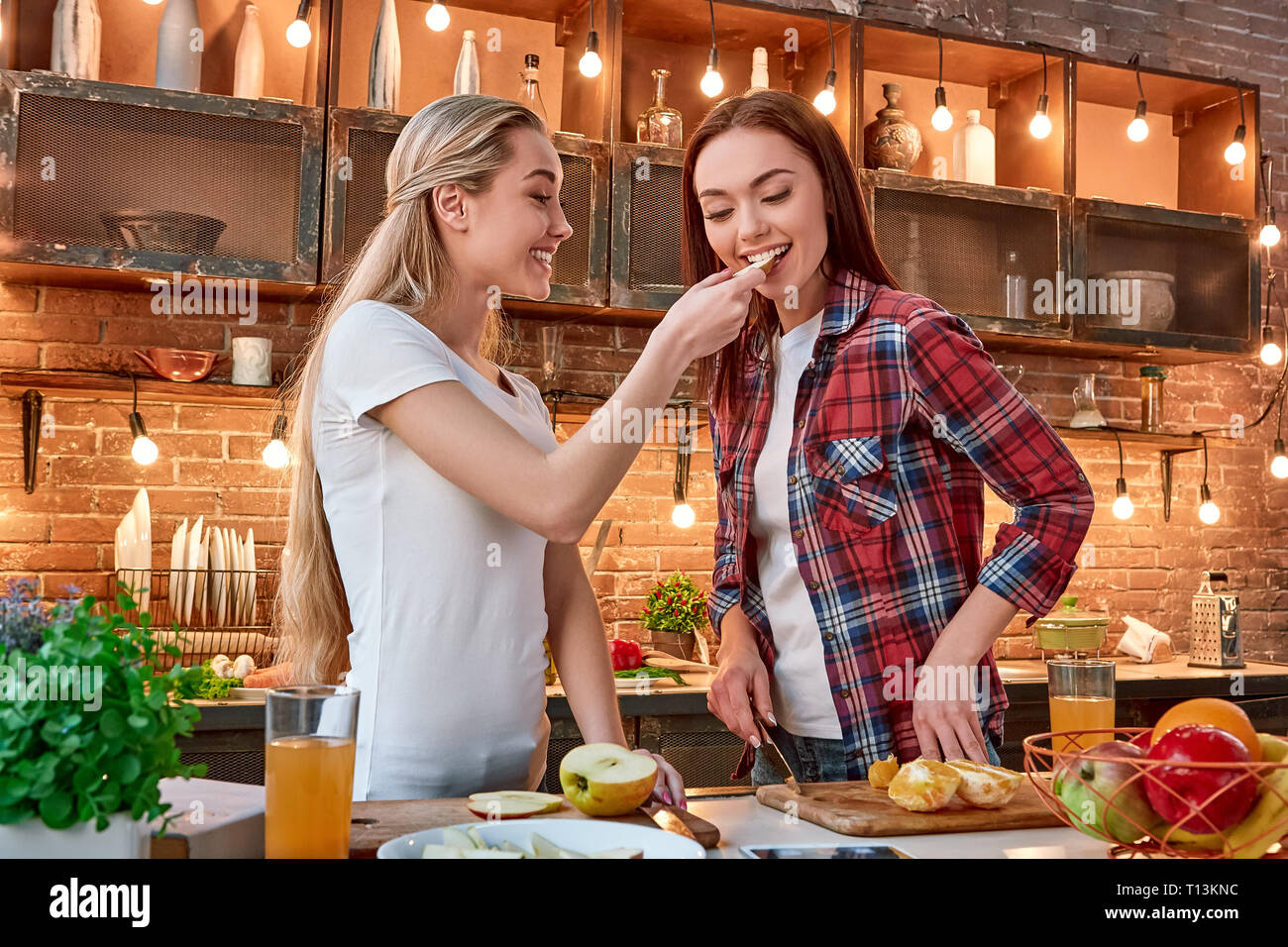 Girl apple tasting friends hi-res stock photography and images - Alamy