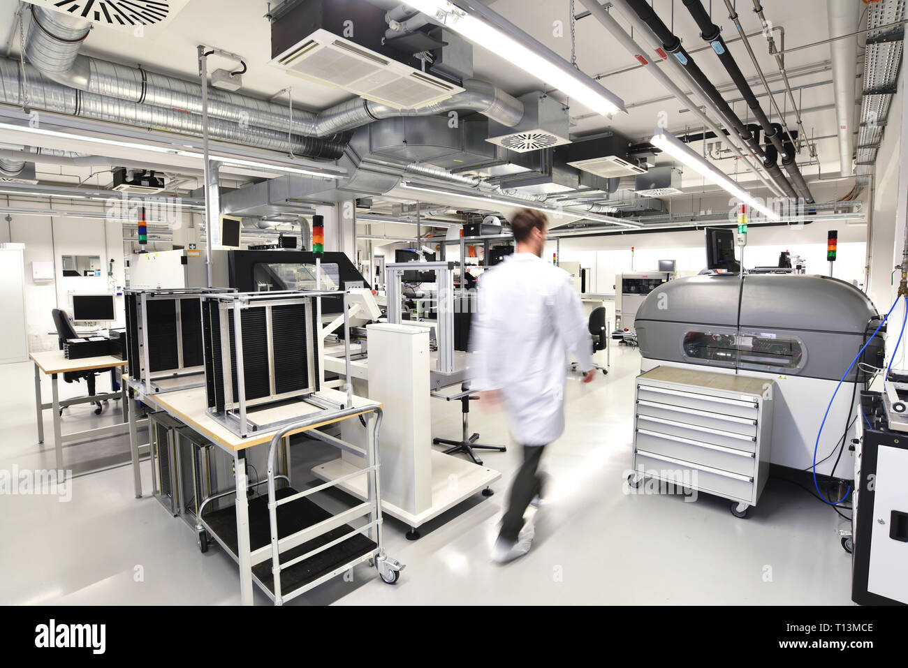 Man walking in a factory for manufacturing of circuit boards for the ...
