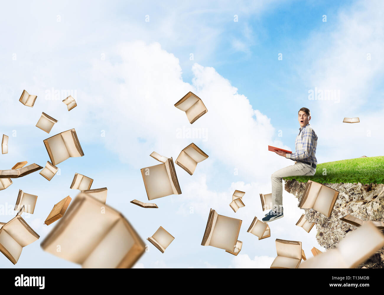 Man reading book and many of them flying in air Stock Photo - Alamy