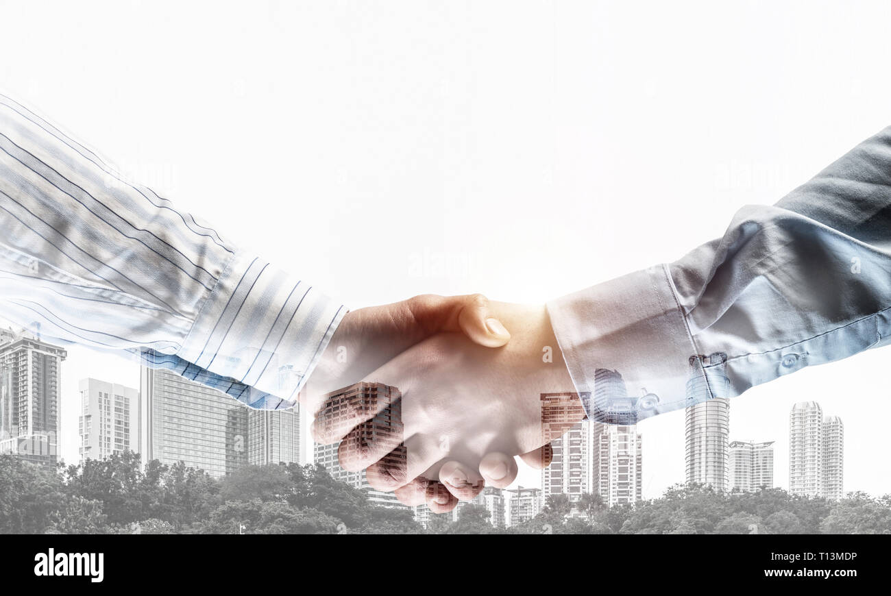 Business handshake as idea for unity and cooperation or greeting. Mixed ...