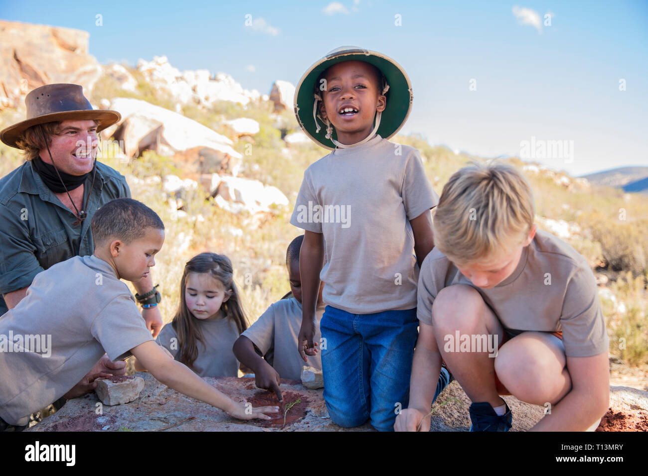 Children at a camp learning from guide Stock Photo - Alamy