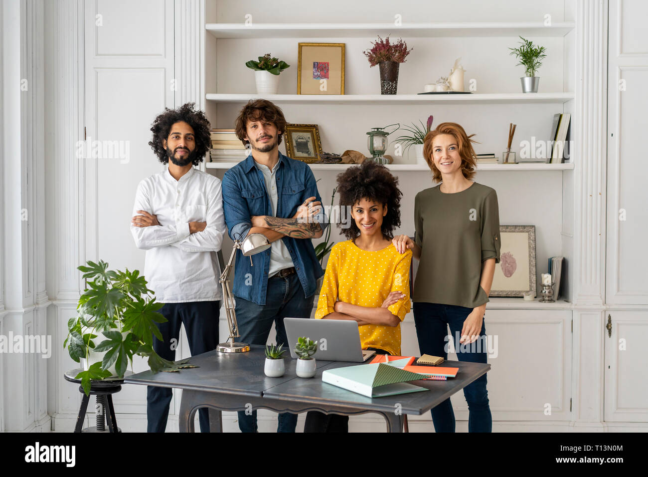 Group of creative professionals stnading in their new office space ...