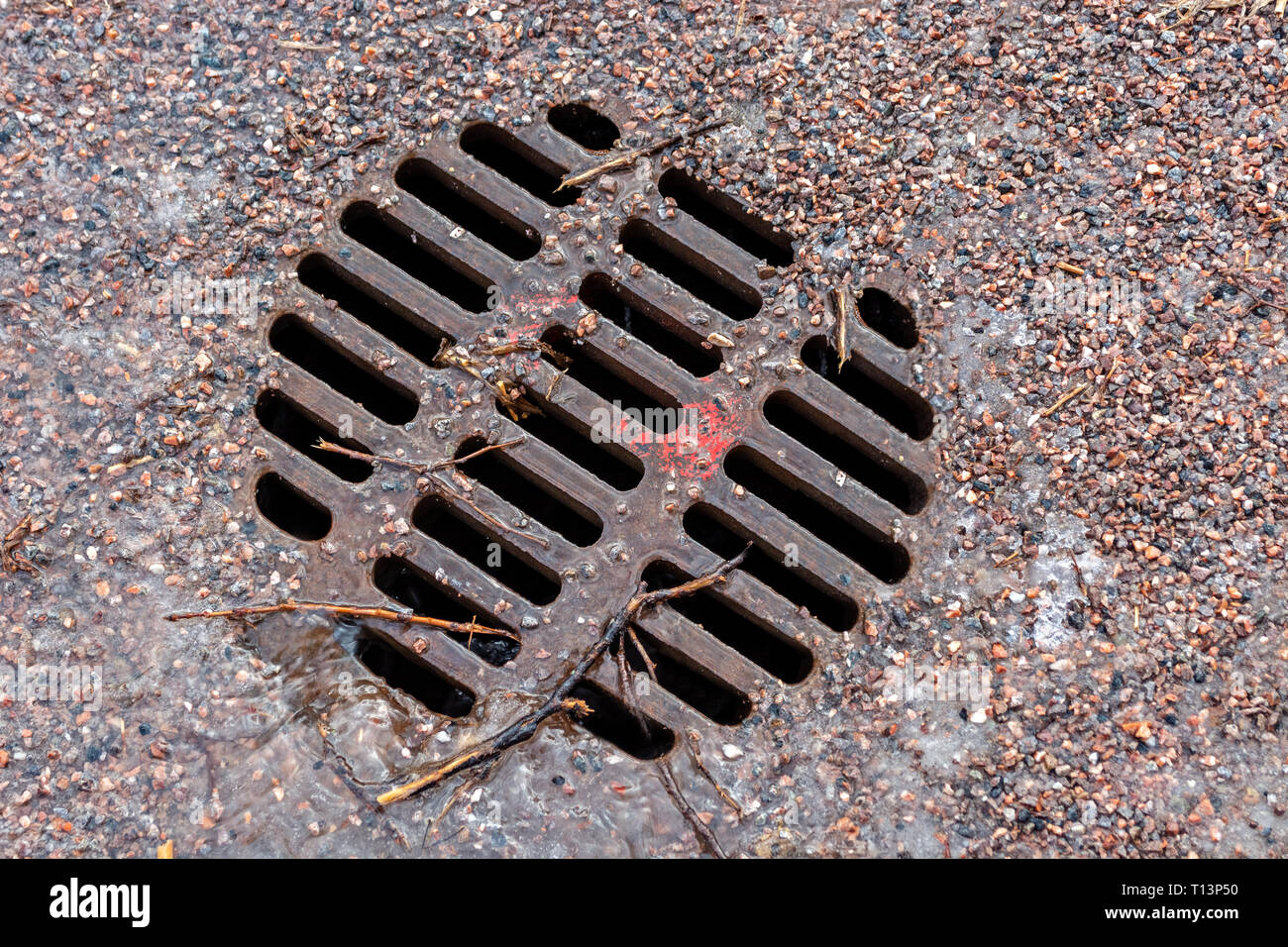 View of the manhole, located on a pedestrian path, with flowing into it ...