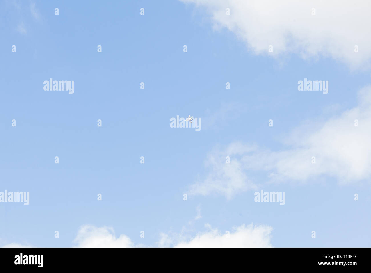 Military fighter in the blue sky with white clouds Stock Photo - Alamy