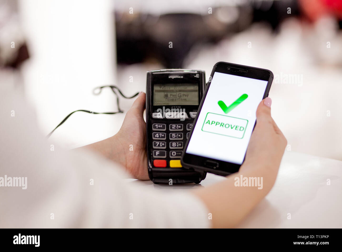 POS terminal, Payment Machine with mobile phone on store background ...