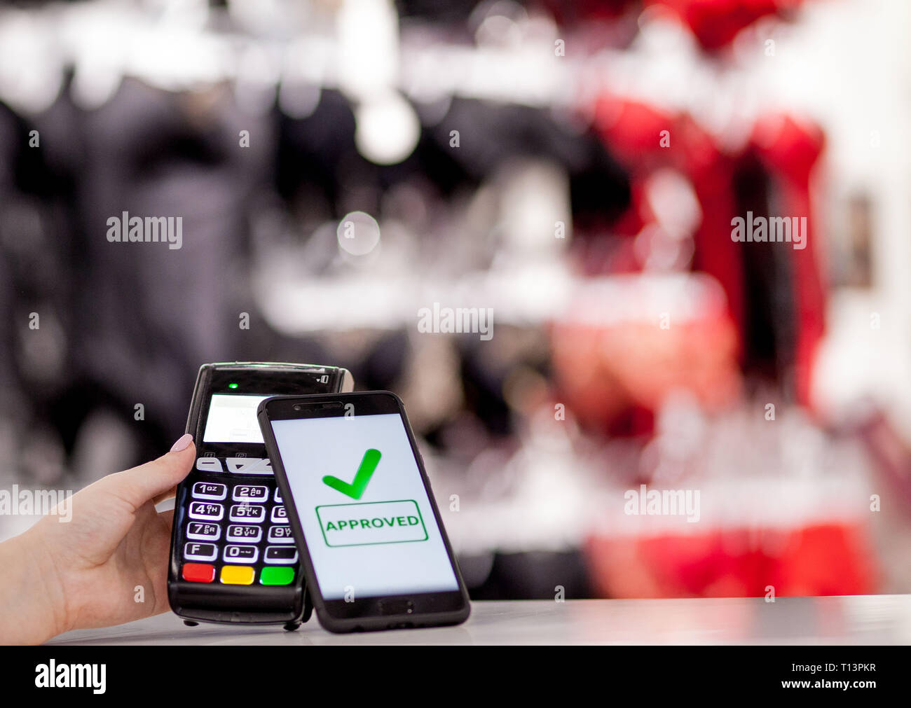 POS terminal, Payment Machine with mobile phone on store background ...