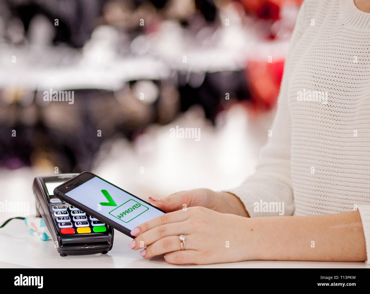 POS terminal, Payment Machine with mobile phone on store background ...