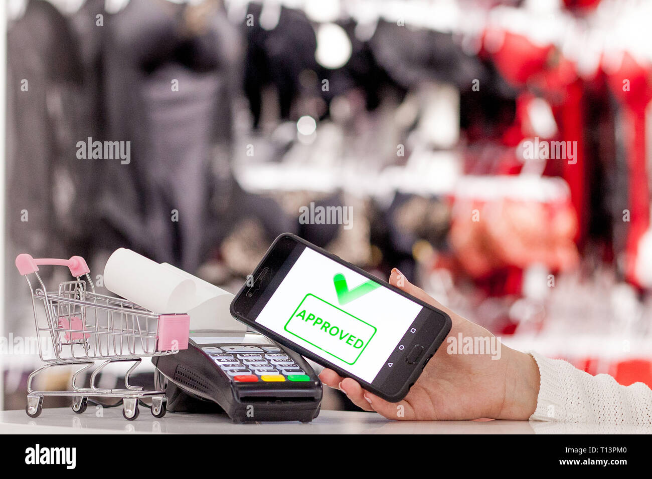 POS terminal, Payment Machine with mobile phone on store background ...