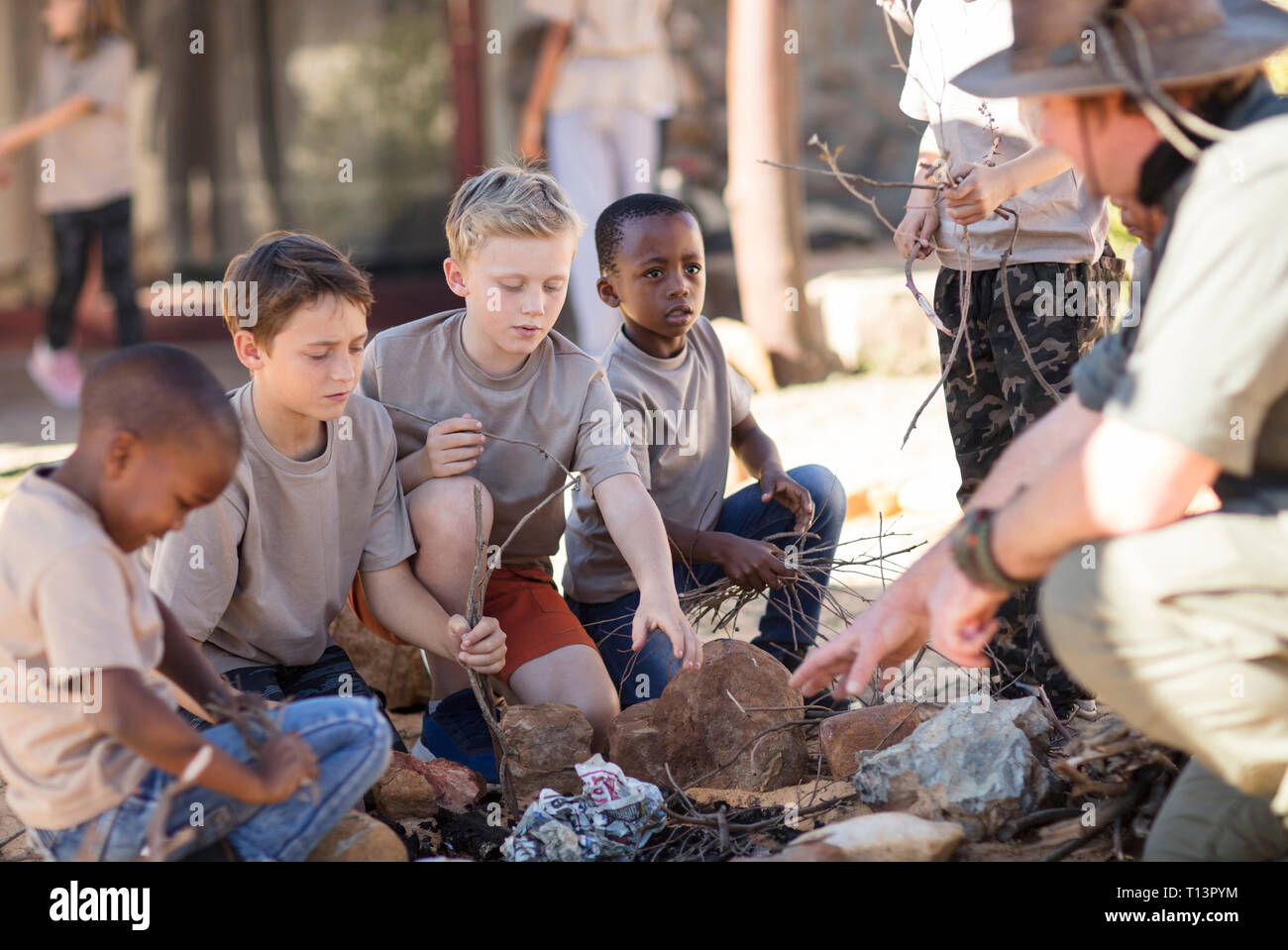 Children learning how to make a fire Stock Photo - Alamy