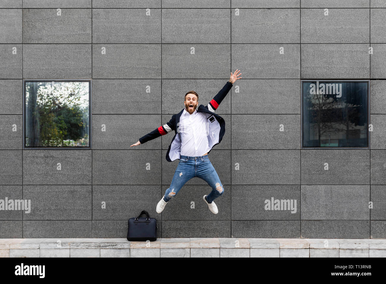 Excited businessman jumping hi-res stock photography and images - Alamy