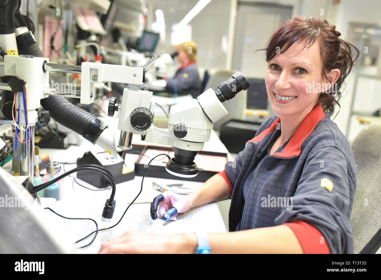 Portrait of smiling woman working on quality control in the ...