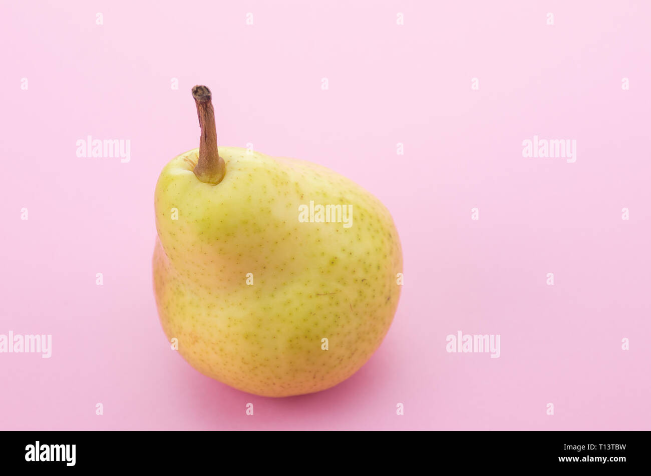 ripe pear fruit on a pastel pink surface Stock Photo - Alamy