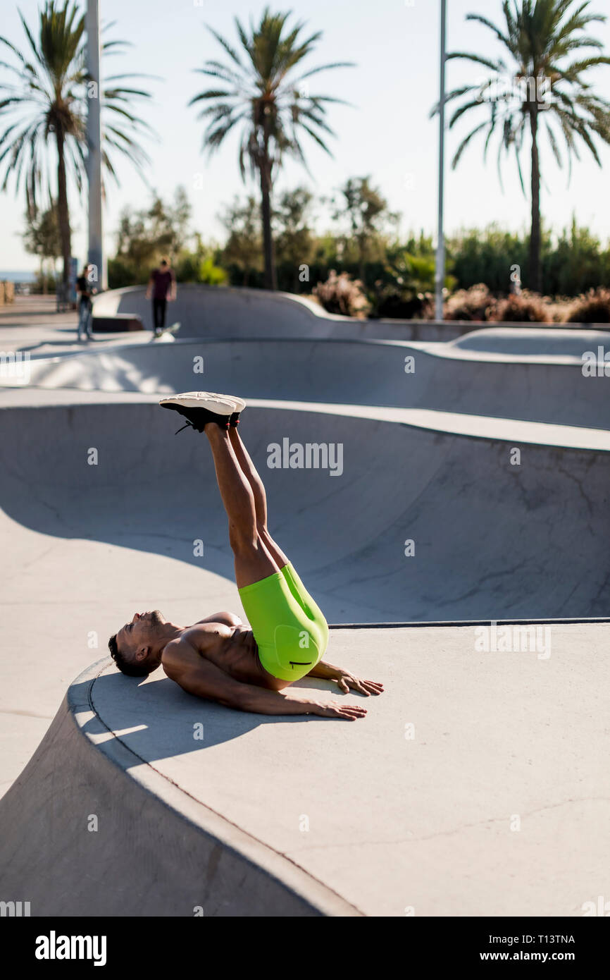 Barechested muscular man exercising in a skatepark Stock Photo - Alamy
