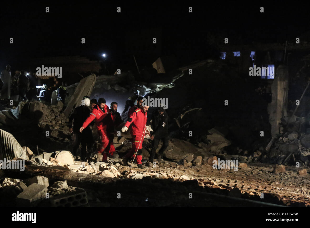 Idlib, Syria. 22nd Mar, 2019. Members of the Syrian civil defence carry ...