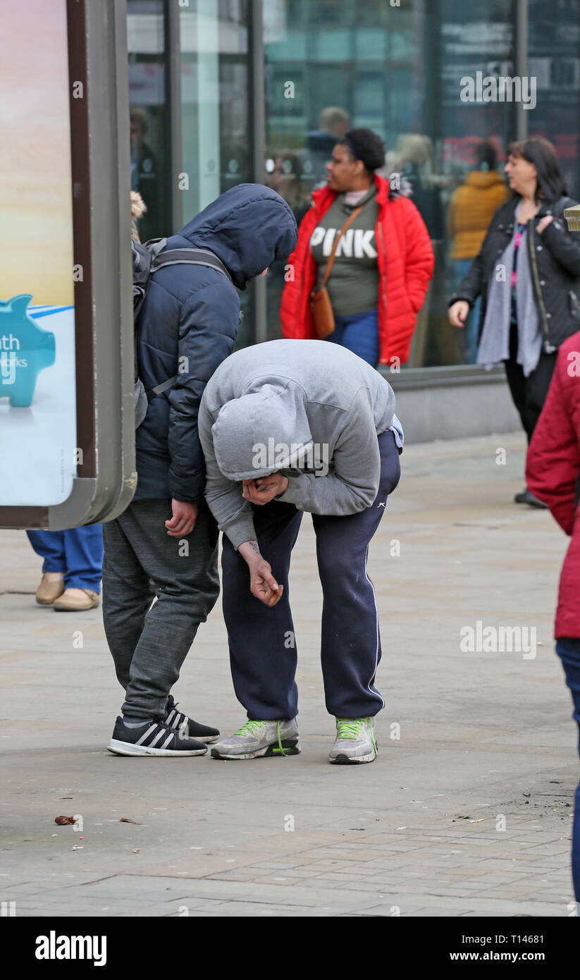 Manchester, UK. 23rd March, 2019. Police Officers assist two men who ...