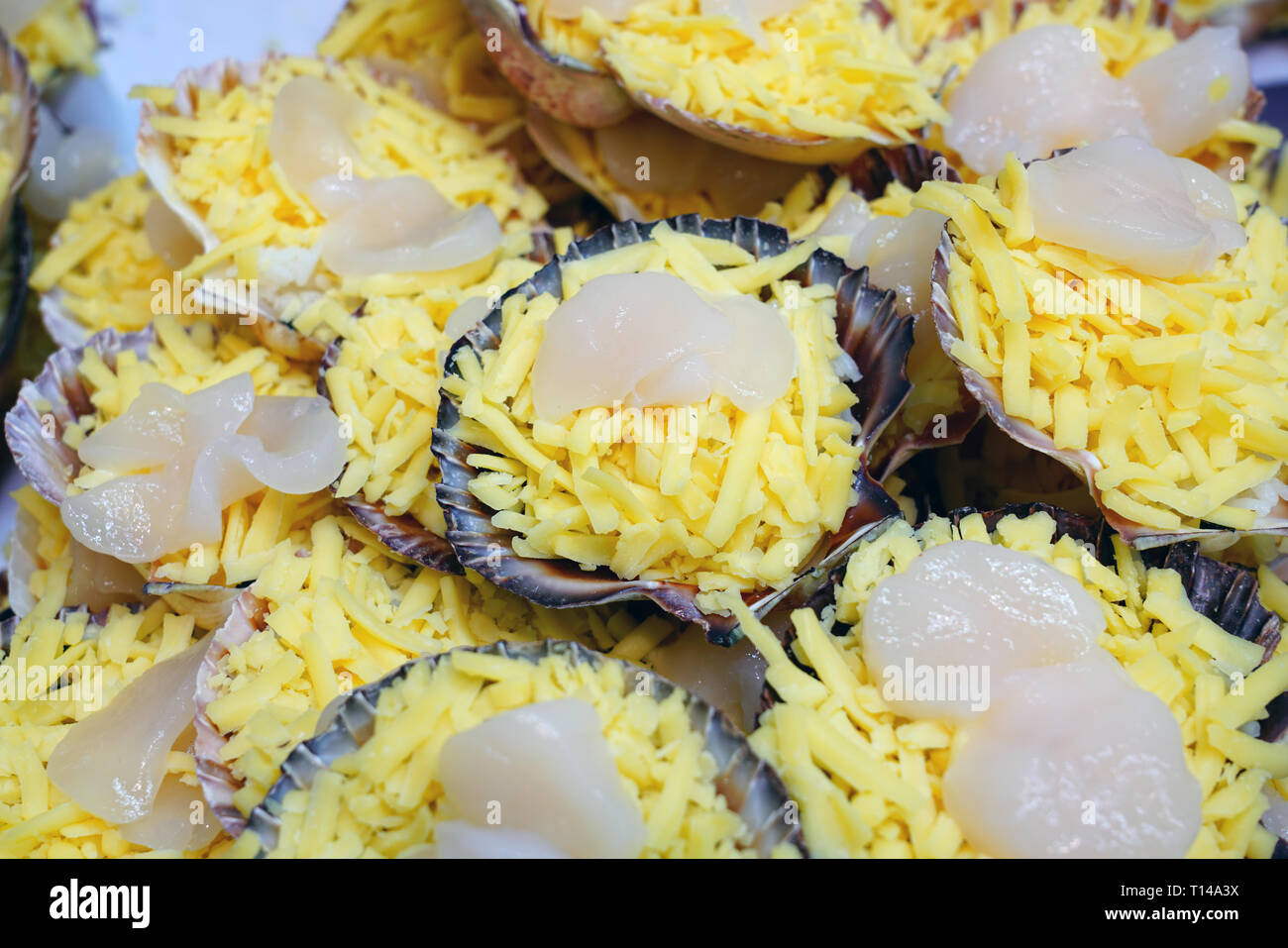 Broiled scallops with cheese on the shell at a fish market in Sydney ...