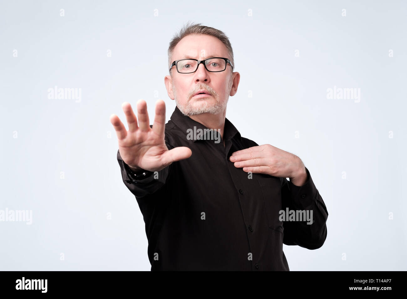 Senior man refusing to accept your opinion Stock Photo - Alamy