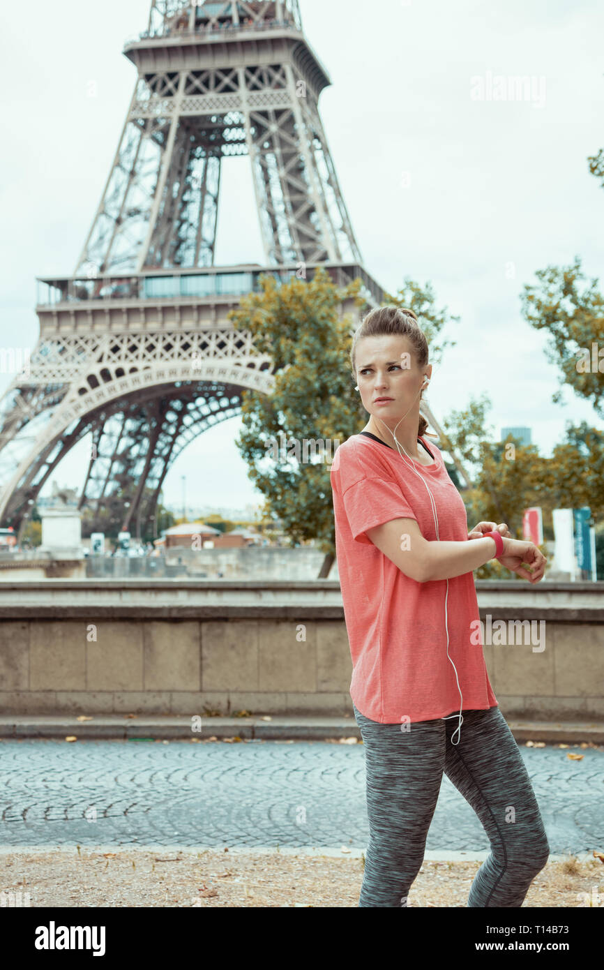 fit sports woman in sport clothes not far from Eiffel tower in Paris ...