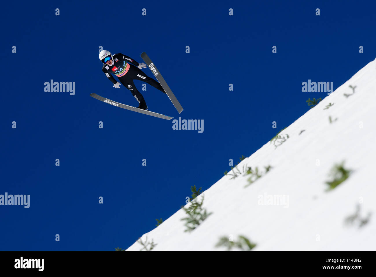Simon Ammann of Switzerland in action during the team competition at ...