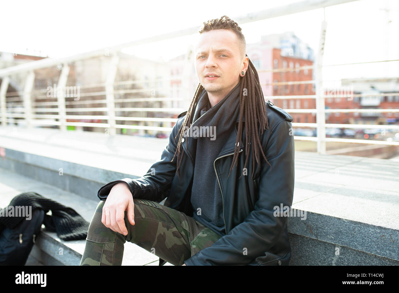 rocker rock star young man walking on the city street autumn day Stock ...
