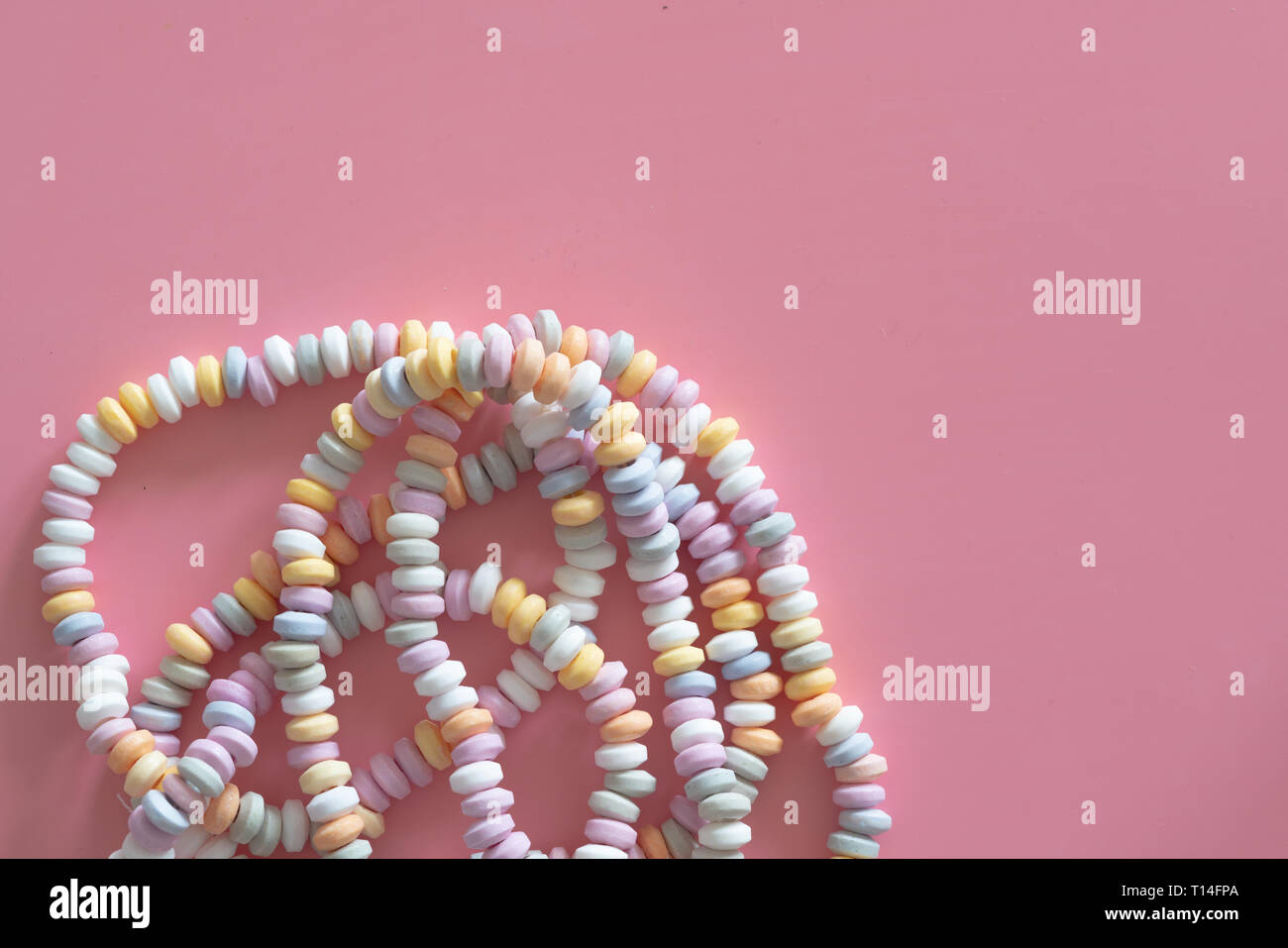 sweets Beads and bracelets candy on pink background Stock Photo - Alamy