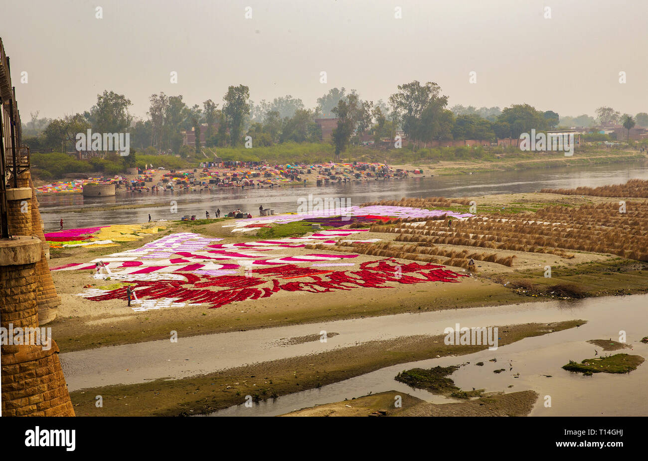 painting and washing of fabrics and clothes on the river Agra India ...