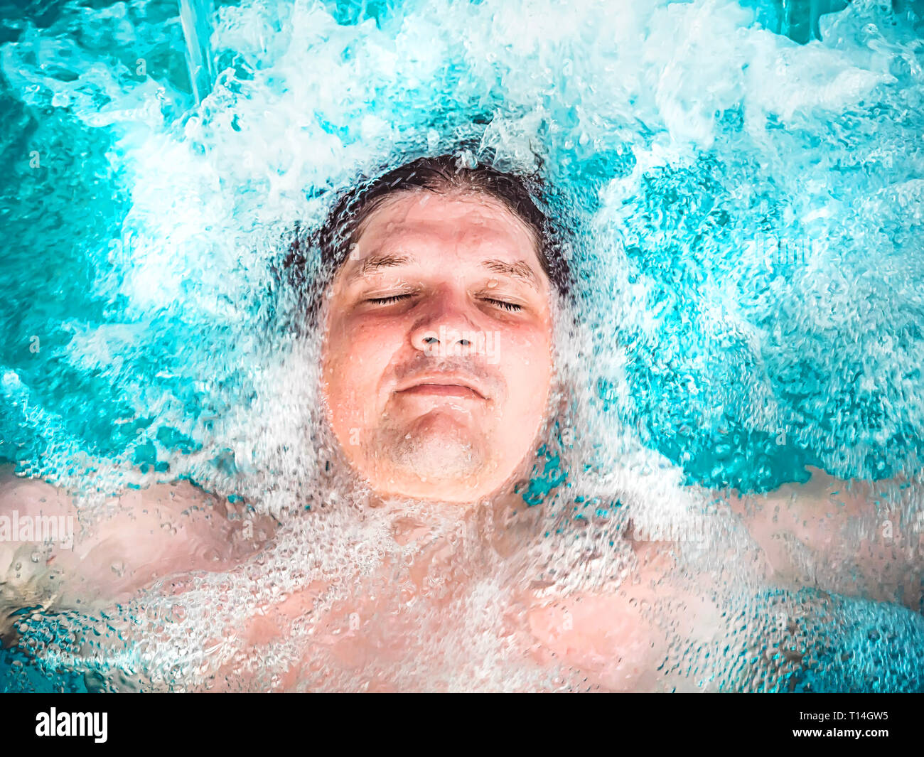 Happy man relaxing in the jacuzzi and closing his eyes. Caucasian boy ...
