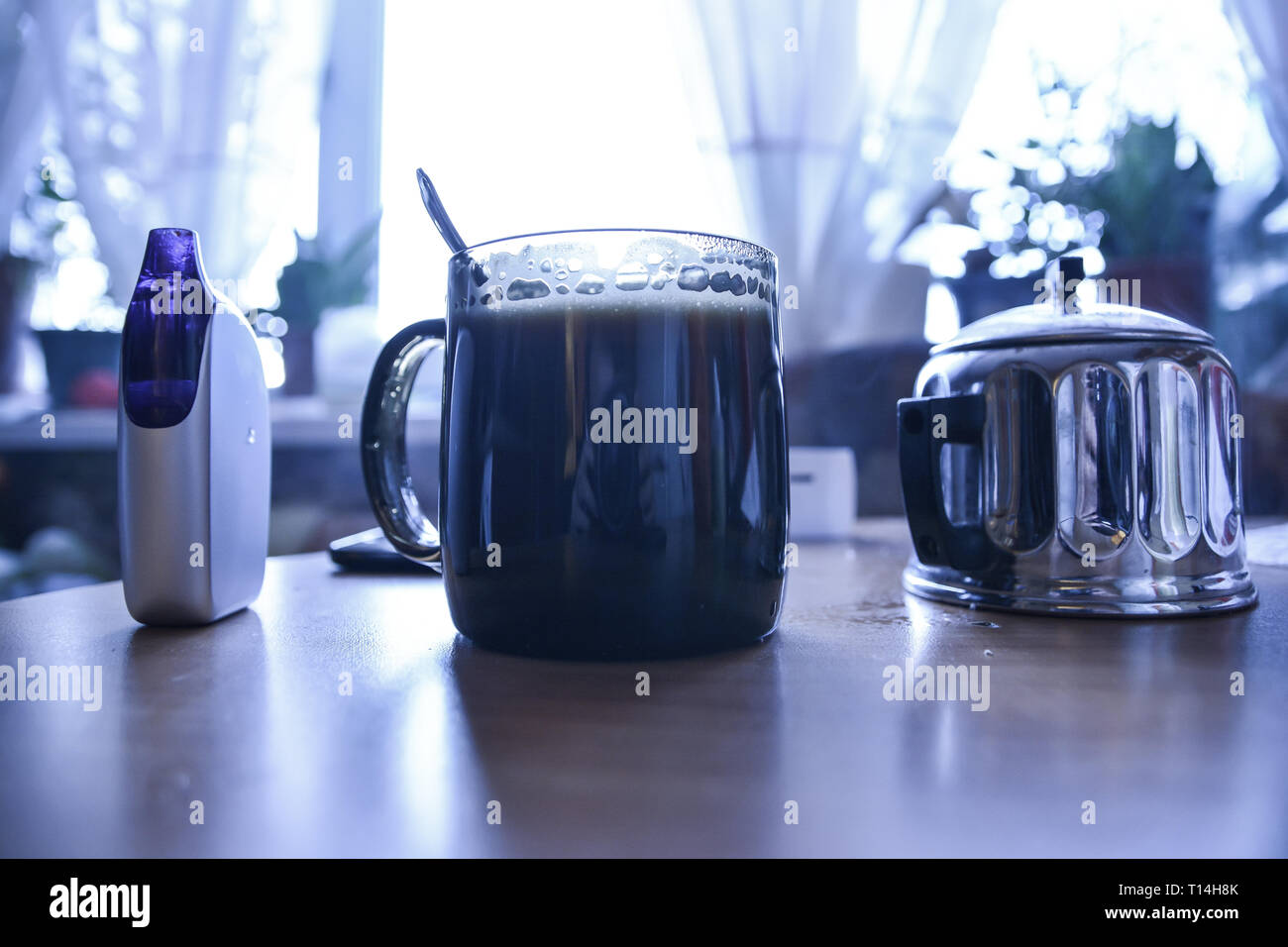 transparent cup with sugar bowl on a blue background Stock Photo - Alamy