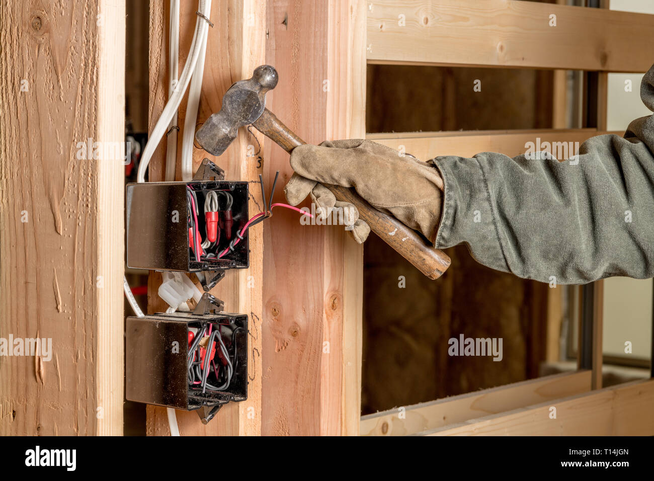 Nail is used to hold an electrical box on the wall Stock Photo - Alamy