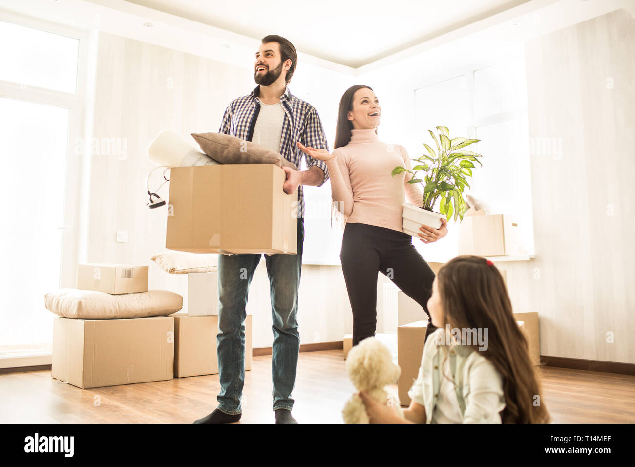 Man and woman are standing close to each other and looking to different ...