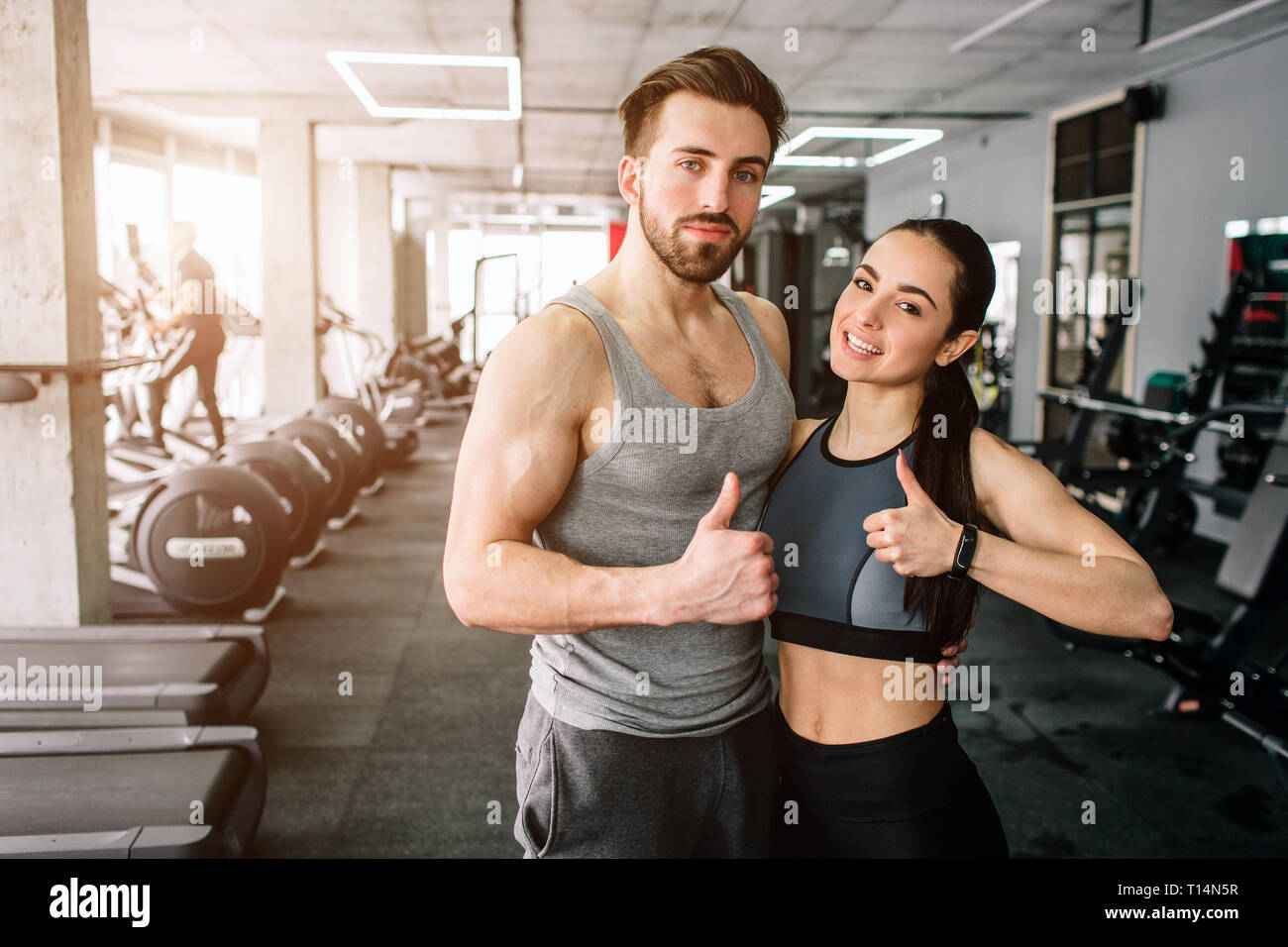 A picture of a couple standing in the sport club's training room ...