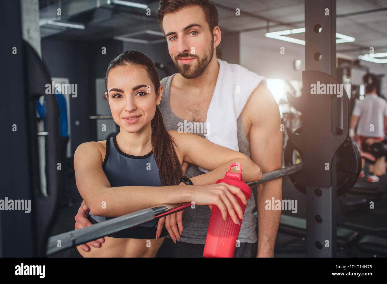Fantastic couple is standing together in the training room and posing ...